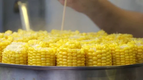 Street fast food. Cooking corn in boiled... | Stock Video | Pond5