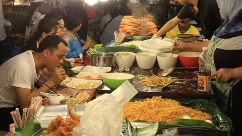 Street food : people eating food at nigh... | Stock Video | Pond5