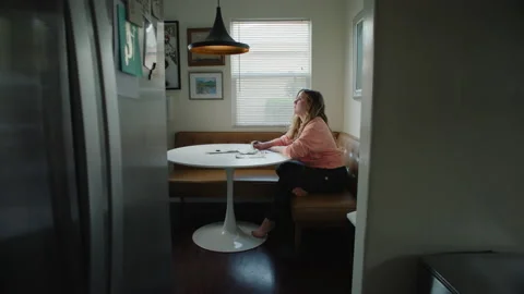 Stressed out Woman Writing at Kitchen Ta... | Stock Video | Pond5