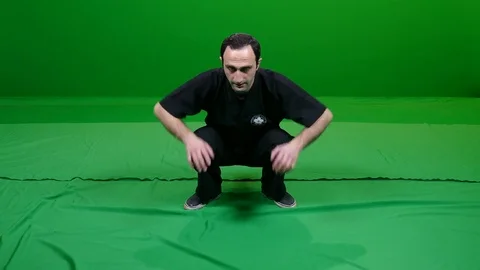 Stretching out Legs on Green Screen | Stock Video | Pond5