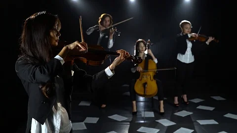 String quartet playing in a dark room on... | Stock Video | Pond5