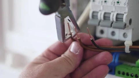 strip electrical wire with plier in elec... | Stock Video | Pond5