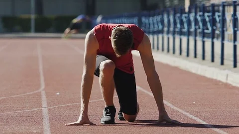 Strong man starts running from crouch st... | Stock Video | Pond5