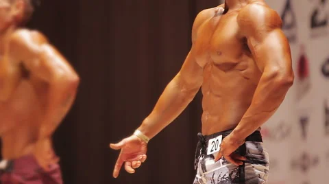 Strong men in shorts standing on stage a... | Stock Video | Pond5