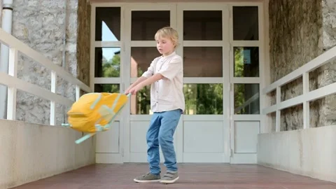 Student boy is spinning with a backpack... | Stock Video | Pond5