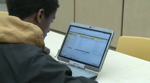 Student looking at computer in classroom... | Stock Video | Pond5