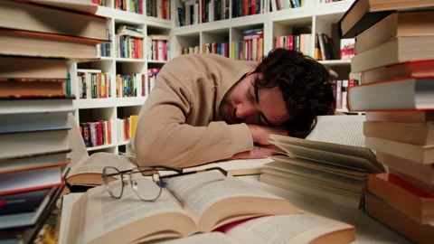 Student Man Sleeping at the Library. Tir... | Stock Video | Pond5