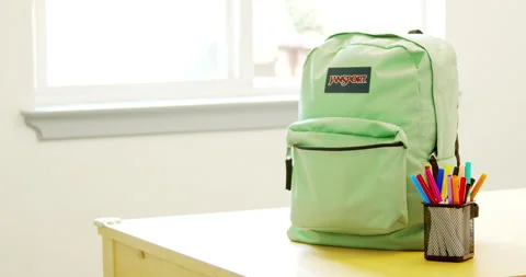 A student packing a school bag pack with... | Stock Video | Pond5