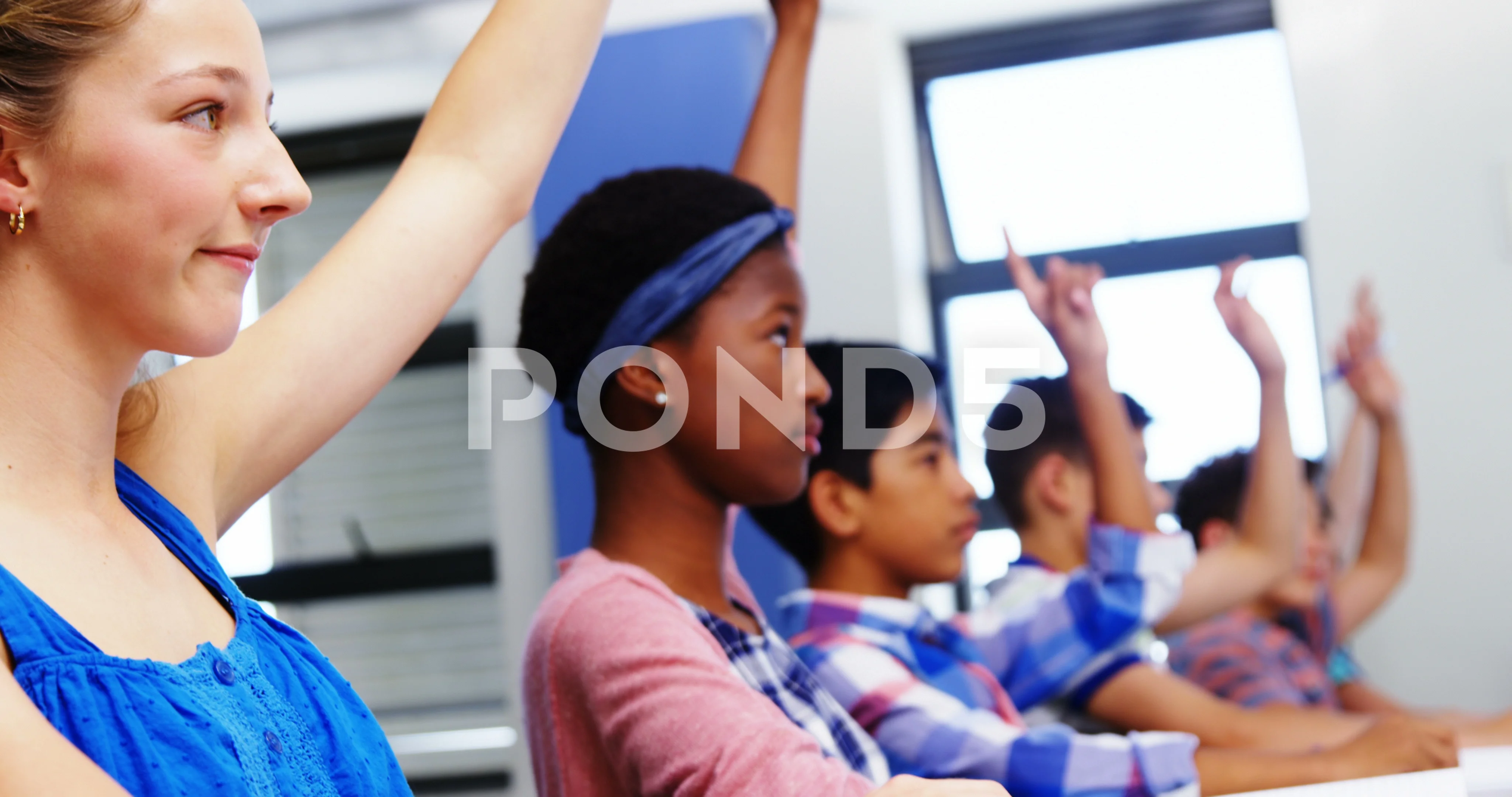 Child Raising Hand In Class