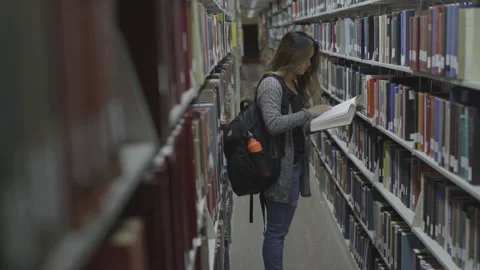 Student Stands In Row Of Library Looking... | Stock Video | Pond5