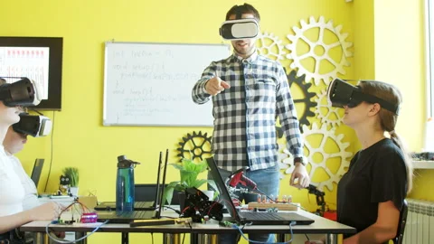 Students and teacher using VR goggles in... | Stock Video | Pond5