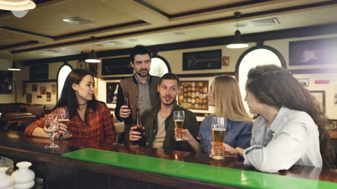 Students are drinking in bar celebrating... | Stock Video | Pond5