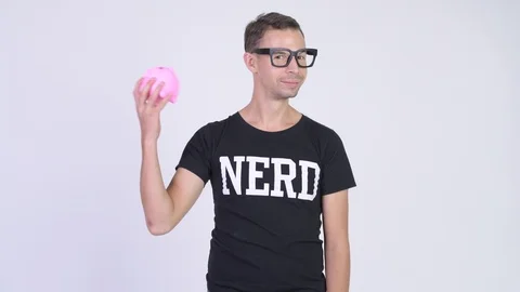 Studio shot of nerd man shaking piggy ba... | Stock Video | Pond5