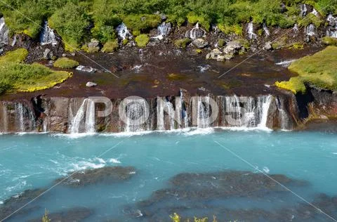 Photograph: A stunning front view of a Hraunfossar series of foamy ...