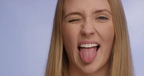 Stunning Woman sticking out tongue | Stock Video | Pond5