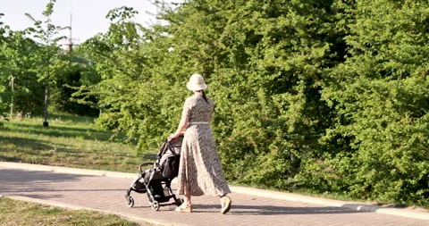 Stunning Young Woman Strolling, Pushing ... | Stock Video | Pond5