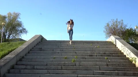 Stylish girl dancing on stairs | Stock Video | Pond5