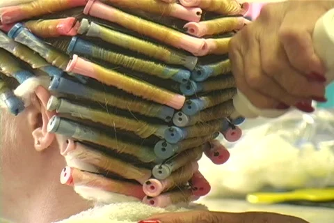 Stylist applying Perm Solution to Perm R... | Stock Video | Pond5