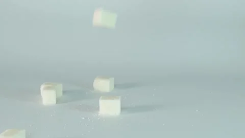Sugar cubes, lumps falling down against ... | Stock Video | Pond5