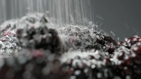 Sugar falls on a spinning blackberry on ... | Stock Video | Pond5