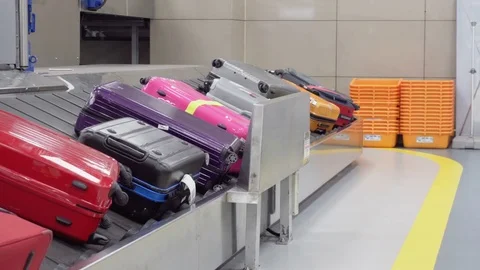 Suitcases on moving luggage conveyor bel... | Stock Video | Pond5