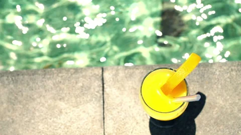 Summer drink with straw by the swimming ... | Stock Video | Pond5