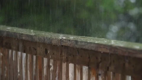 Summer rain falling on wood handrail. Ha... | Stock Video | Pond5