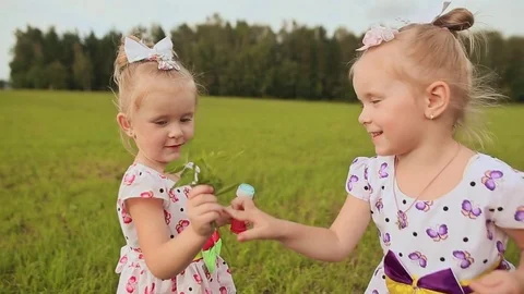 In summer, small twin sisters play in th... | Stock Video | Pond5