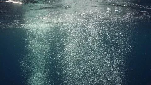 Sun beams penetrate water surface on bub... | Stock Video | Pond5