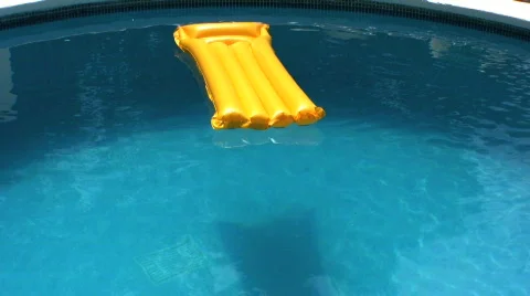 Sun bed floating in a pool | Stock Video | Pond5