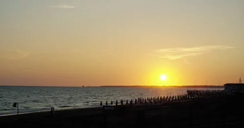 sun falling down at sunset by the beach ... | Stock Video | Pond5