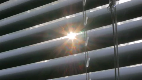 Sun lens flare through window louvers | Stock Video | Pond5