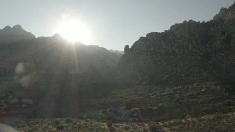 Sun Rays over Rocky Hills in Desert | Stock Video | Pond5