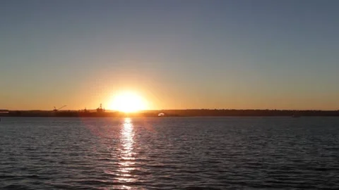 Sun setting over water in bay with silho... | Stock Video | Pond5