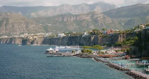 Sunlit bay with piers for boats washed b... | Stock Video | Pond5