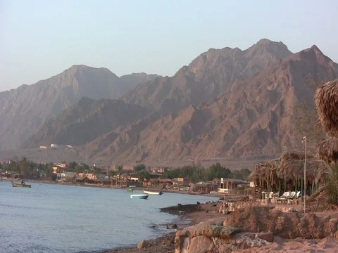 Sunny side view of sea waves a few boats... | Stock Video | Pond5