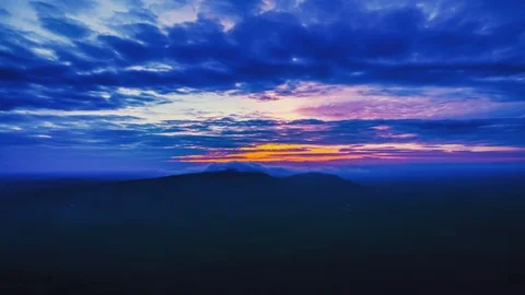 Sunrise with mist and clouds moving in m... | Stock Video | Pond5