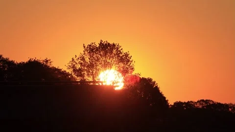 Sunrise real time Sun Rising Behind Of T... | Stock Video | Pond5