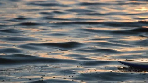 sunrise reflection on water closeup on r... | Stock Video | Pond5