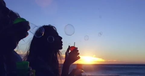 Sunset, beach bubbles and silhouette of ... | Stock Video | Pond5