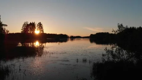 Sunset on lake. Flying forward to the la... | Stock Video | Pond5