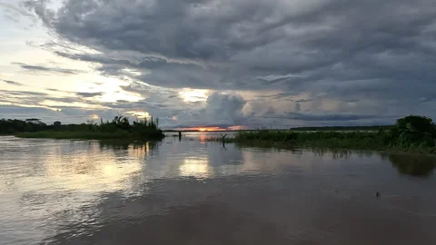 Sunset over the Amazon river and rain fo... | Stock Video | Pond5