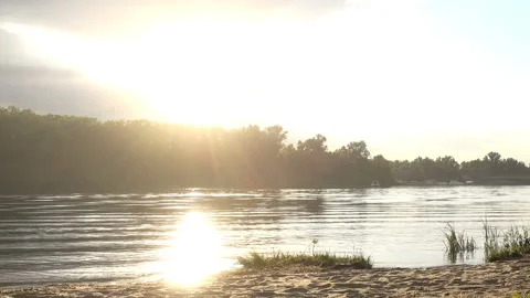 Sunset on the river bank in the forest. | Stock Video | Pond5