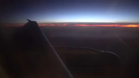 Sunset sky view and plane wing from the ... | Stock Video | Pond5
