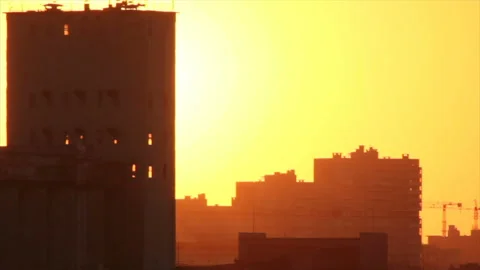 Sunset sun appear between buildings | Stock Video | Pond5