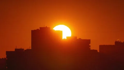 Sunset sun setting behind city buildings... | Stock Video | Pond5