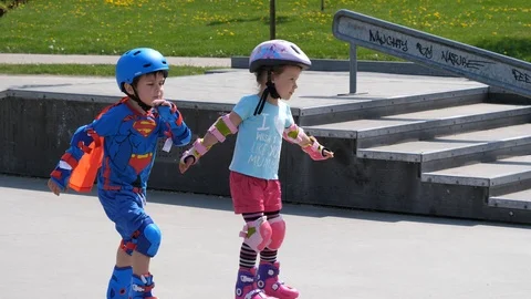 Superman costume kid boy ride rollers on... | Stock Video | Pond5