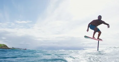 Surfer on hydrofoil surfboard riding blu... | Stock Video | Pond5