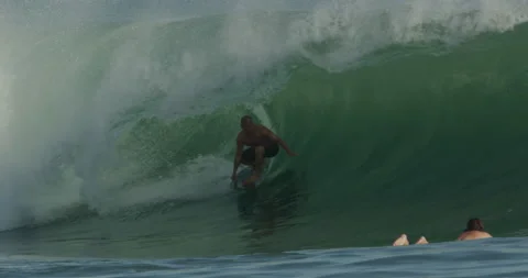 Surfers surfing big waves | Stock Video | Pond5