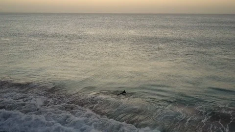 Surfers Swimming in the Waves of the Atl... | Stock Video | Pond5